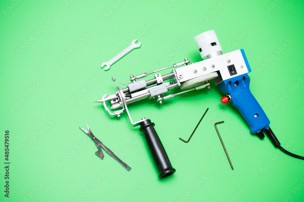 Repair and replacement of tools on a tufting pistol in female hands on ...