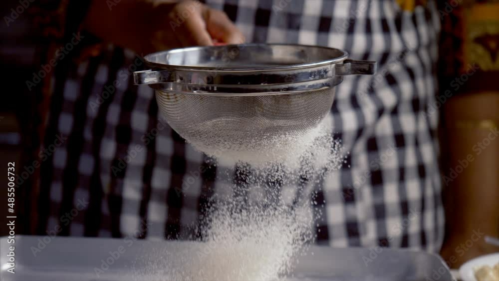 Extreme-closeup shot of particles of white refined flour falling ...