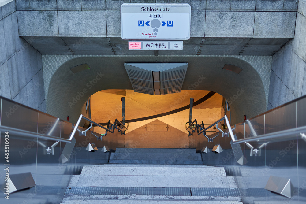 Steps down to the subway station. Illuminated exit to public transport ...