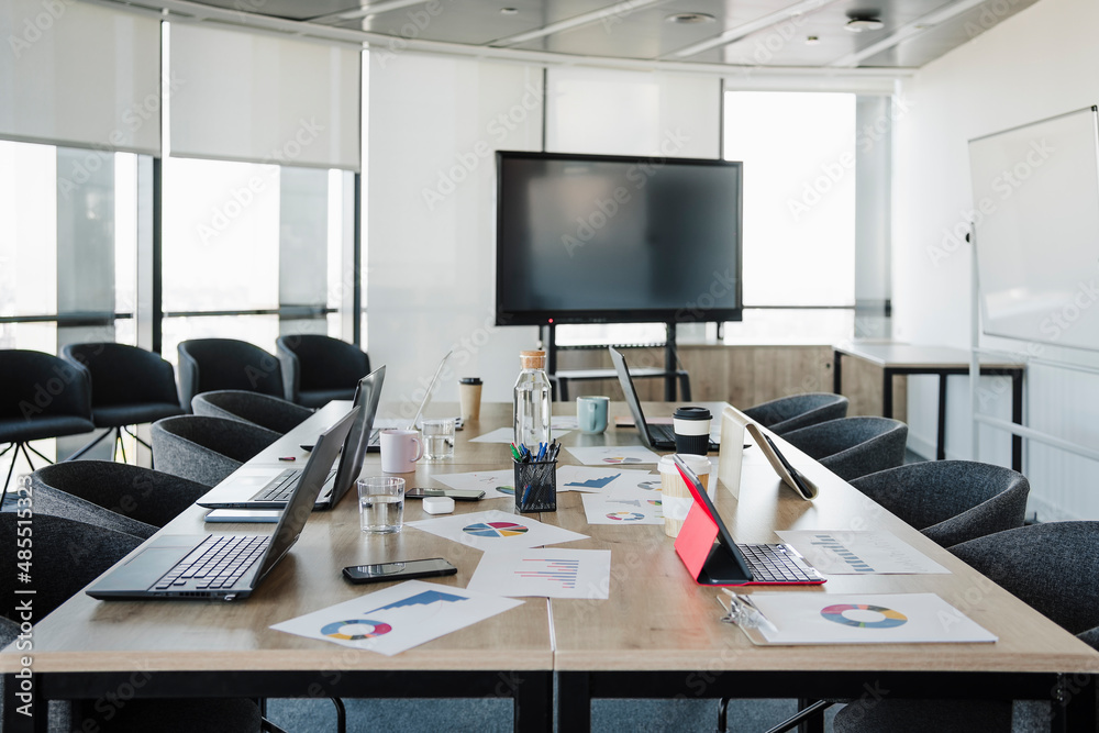 Laptops and graphs kept on conference table in empty meeting room Stock ...