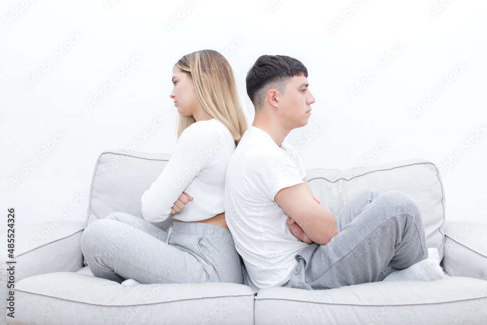 Angry couple sitting in the sofa back to back with crossed arms. Mad ...