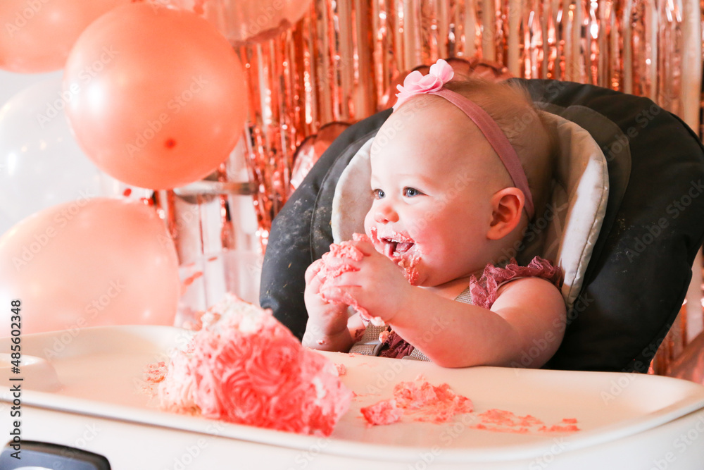Cute birthday girl celebrating her one year birthday by messily eating ...