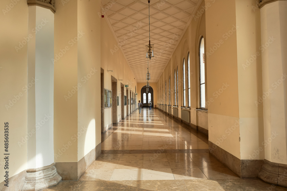 Students walk through a corridor with large windows Stock Photo | Adobe ...