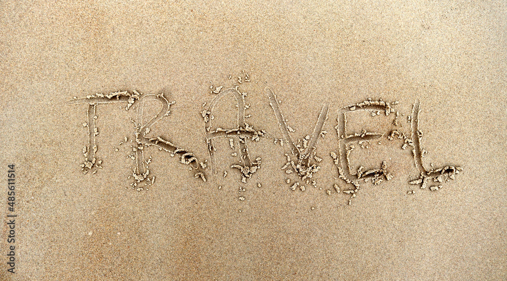 Write word "TRAVEL" in cursive on sand with open tourism concept. Stock ...