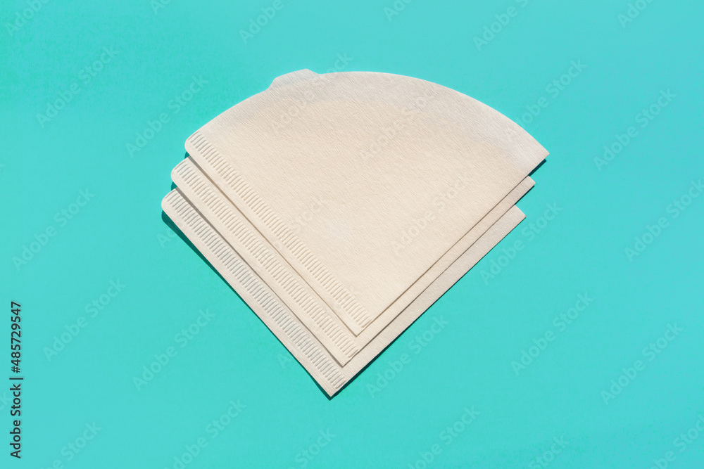 Bleached paper coffee filter isolated on light blue background ...
