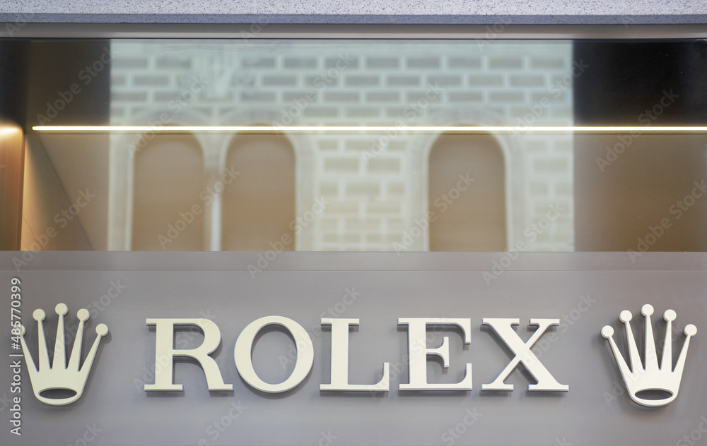 Rolex, sign and logo of the prestigious Swiss brand on the window of a ...