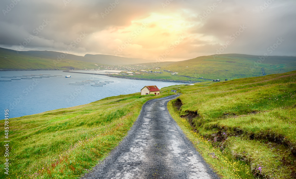 Beautiful trekking path at sunset with green meadows and views of the ...