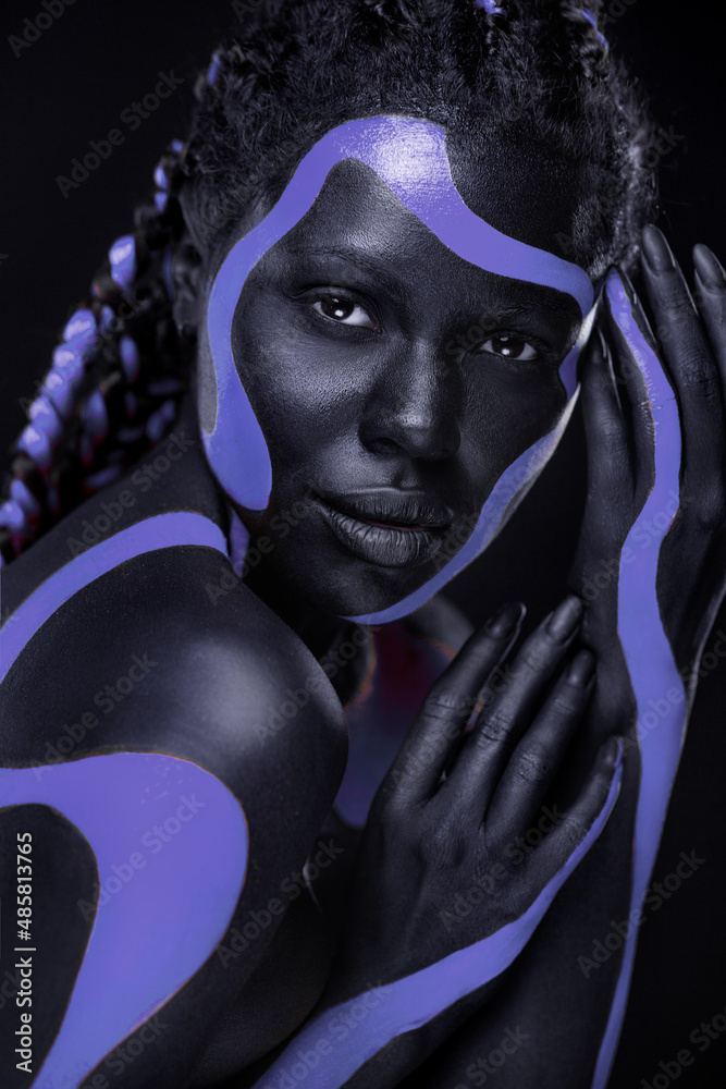 Purple and black body paint. Woman with face art. Young girl with ...