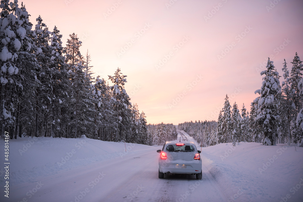 Car driving on icy snow covered roads on a road trip while travelling ...