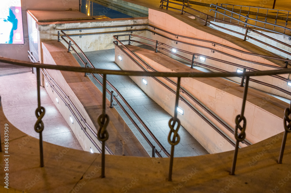 Large access ramp to a building for disabled people. Safety railing and ...
