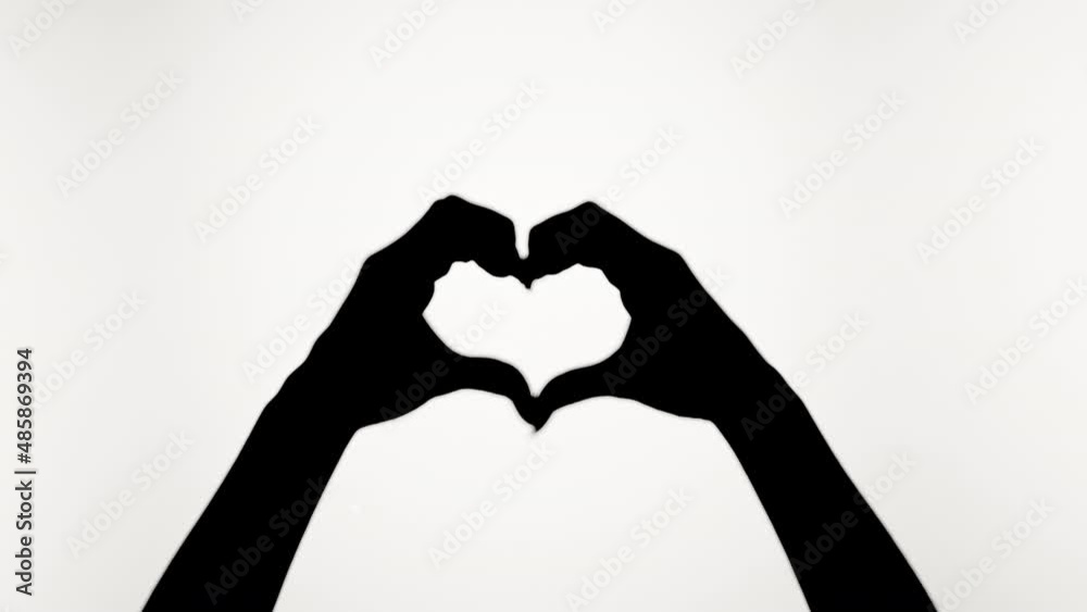 Human showing heart with hands, shadow silhouette isolated on white ...