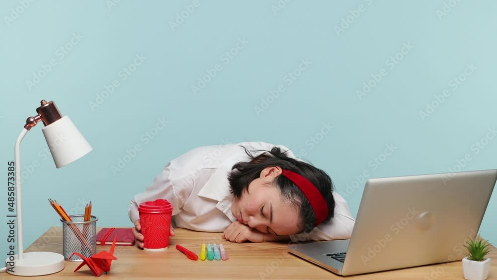 Exhausted young business woman of Asian ethnicity 20s in casual shirt ...