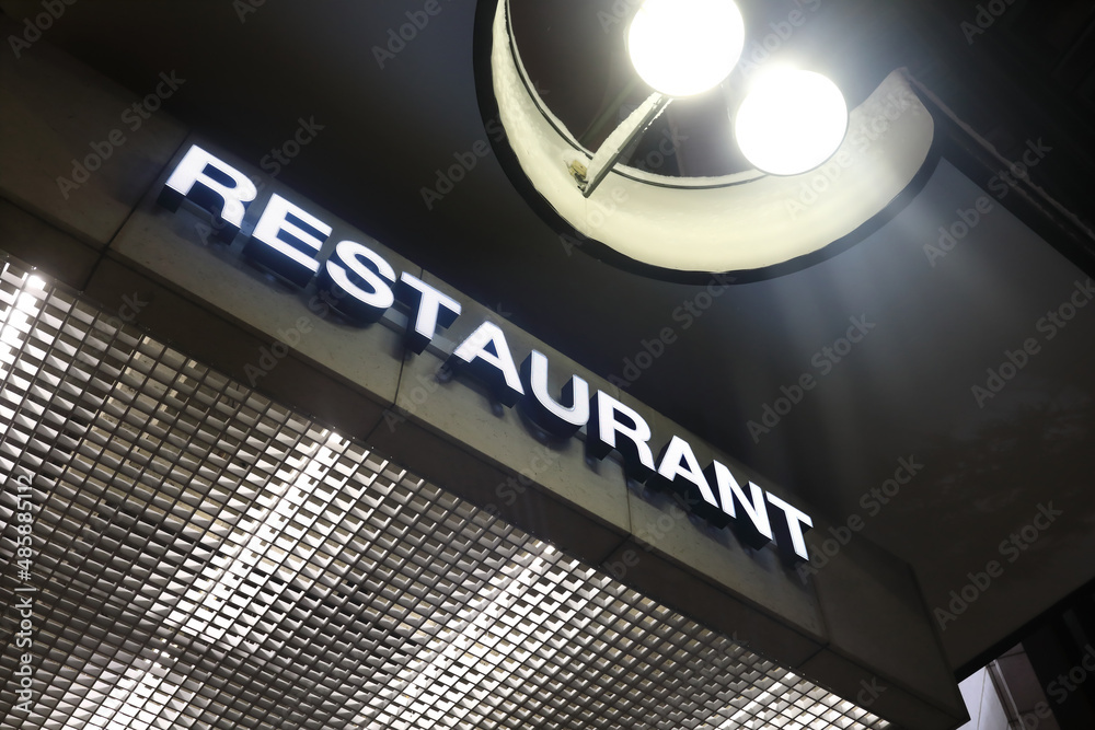 Glowing restaurant sign board at night Stock Photo | Adobe Stock