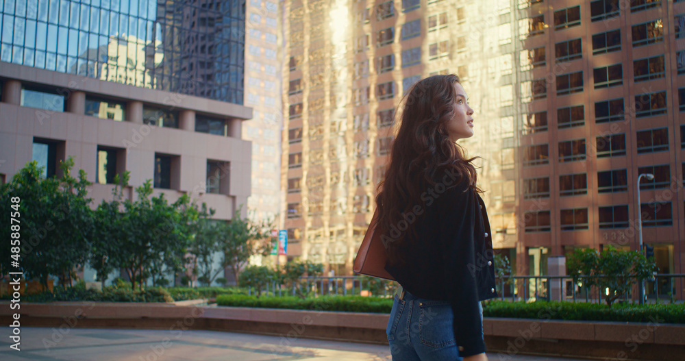 Asian woman going street back view. Lady look around high urban ...