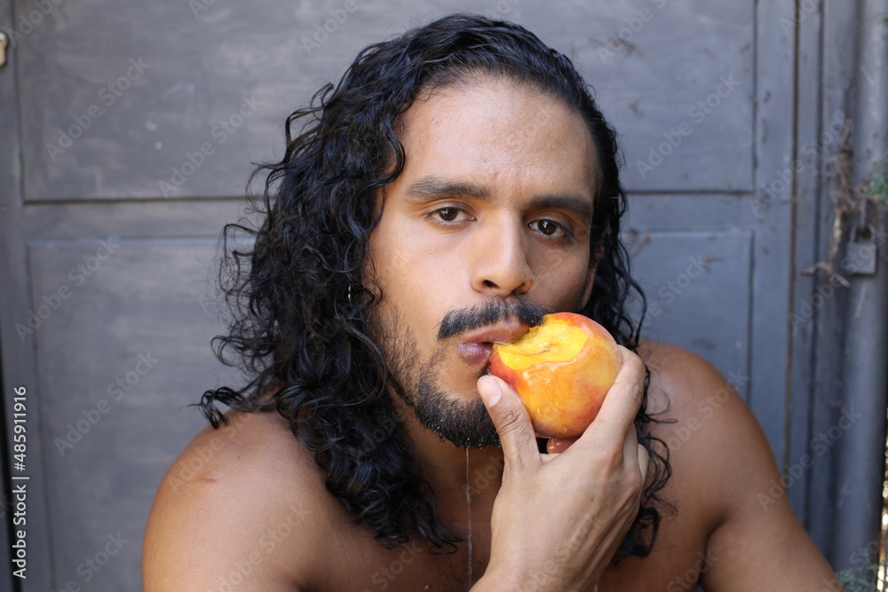 Man eating an irresistible looking peach Stock Photo | Adobe Stock