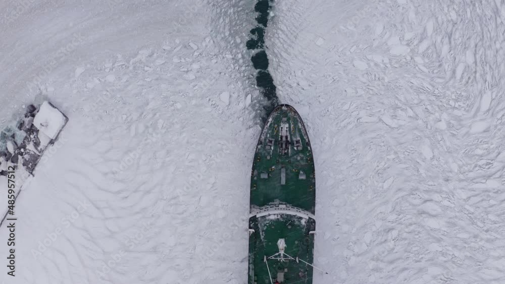 A huge icebreaker breaks the ice with the bow of the ship and floats in ...