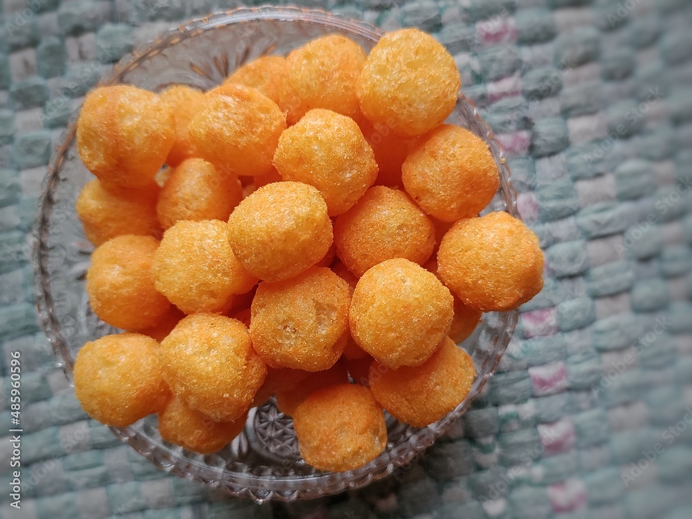 Cheese puffs balls, cheese curls, cheese ball puffs, cheesy puffs, or ...