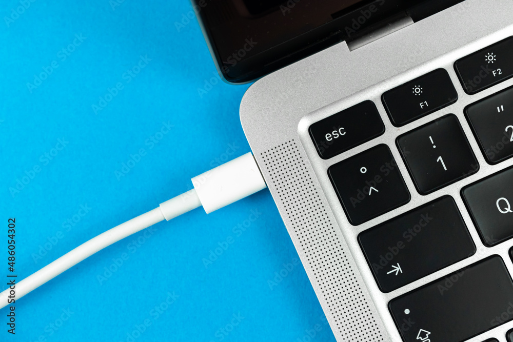 Charging laptop with modern USB Type C port. Laptop low battery concept ...