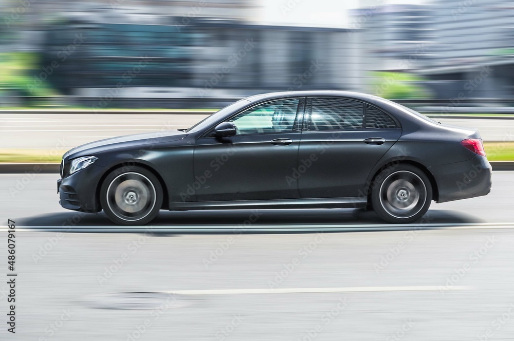 fast moving matte black car with motion blur effect. overspeed concept ...