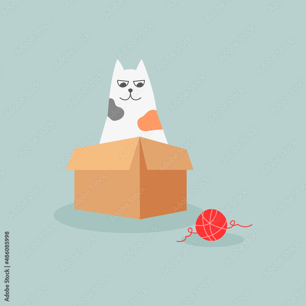 A cat in a cardboard box looks at a ball of yarn. Kitty is inside a cardboard box. A playful ...
