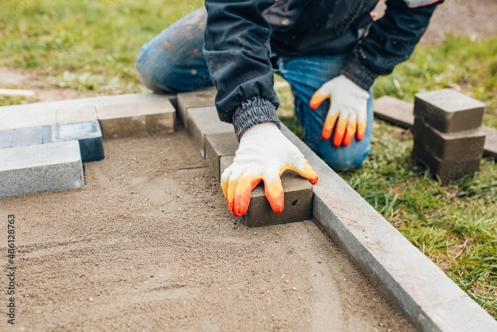 Professional laying of road stone and paving slabs for walking and ...