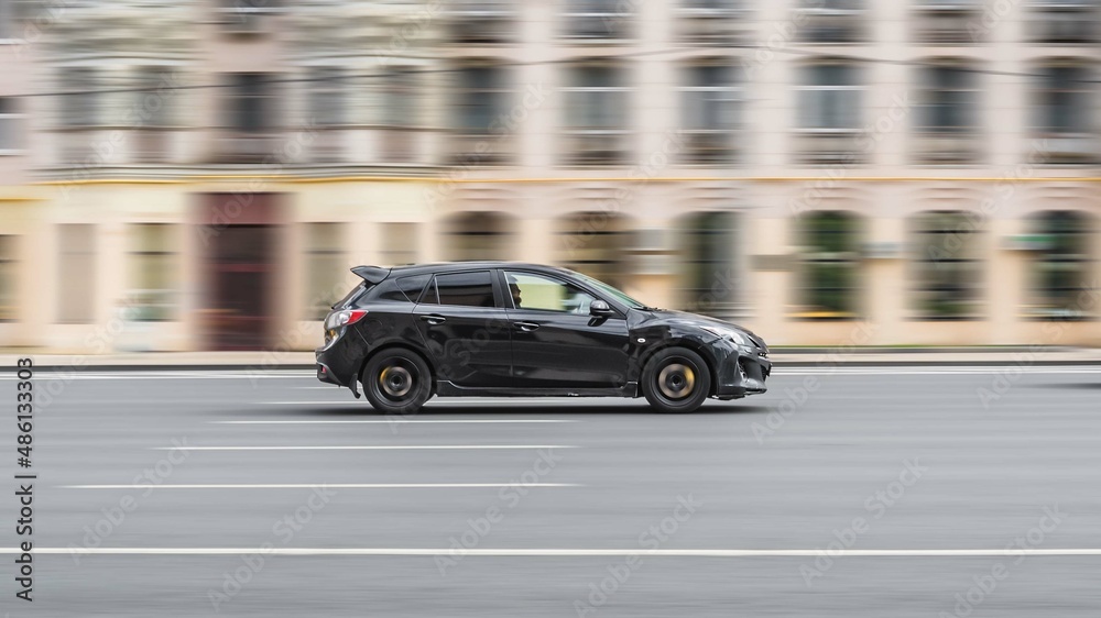 Mazda3 MPS car is driving on high speed in front of classic vintage ...