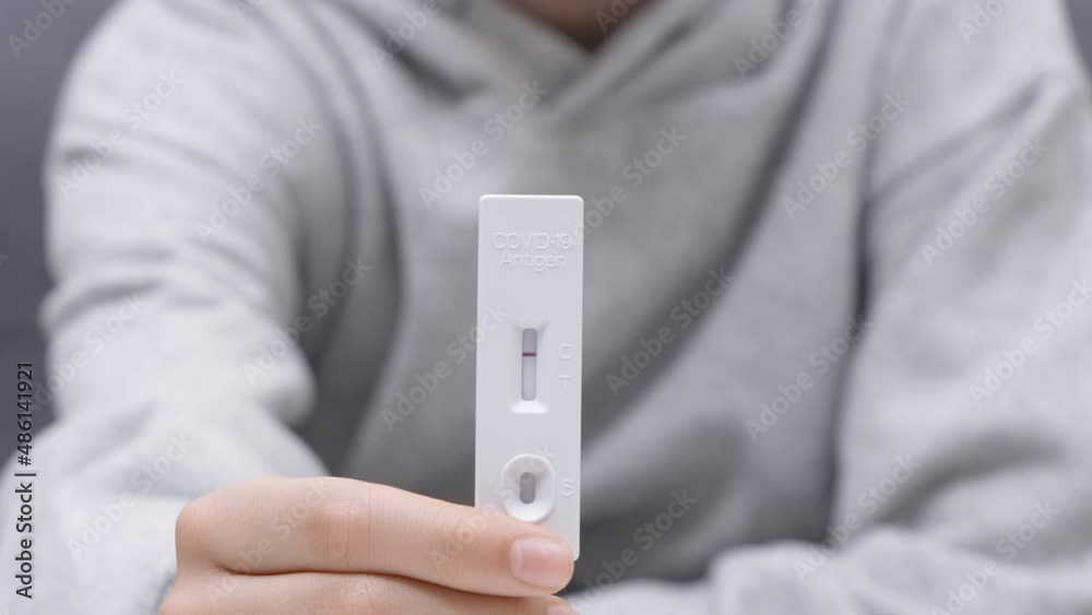 Coronavirus pandemic protection. Teenager using rapid antigen test kit ...