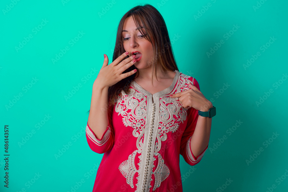 Shocked young beautiful moroccan woman wearing traditional caftan dress ...