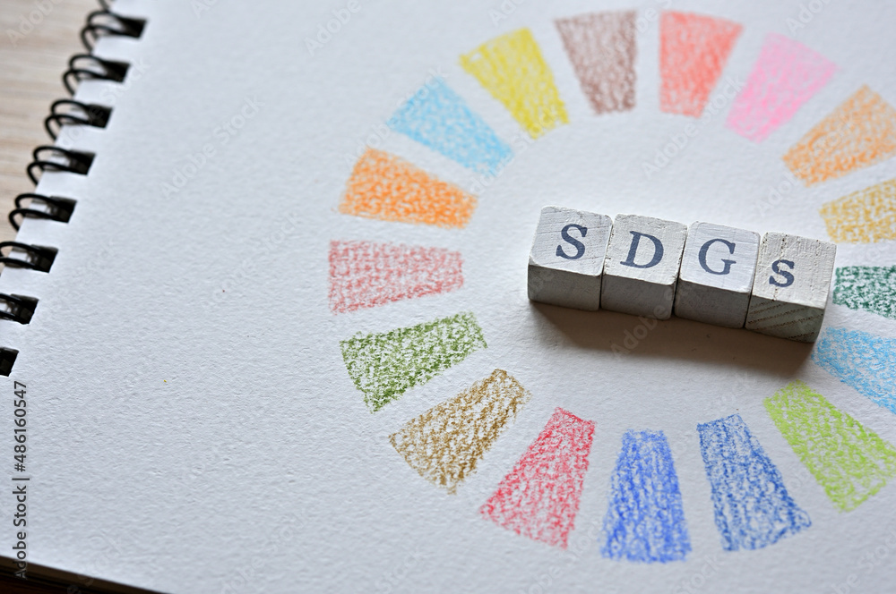 White word cube arranged in the word SDGs It's an abbreviation for ...