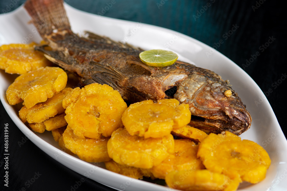 Fried fish with green plantain chips Stock Photo | Adobe Stock