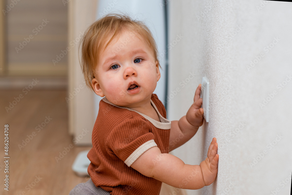 Children's curiosity is a danger to life - baby girl touching a socket ...