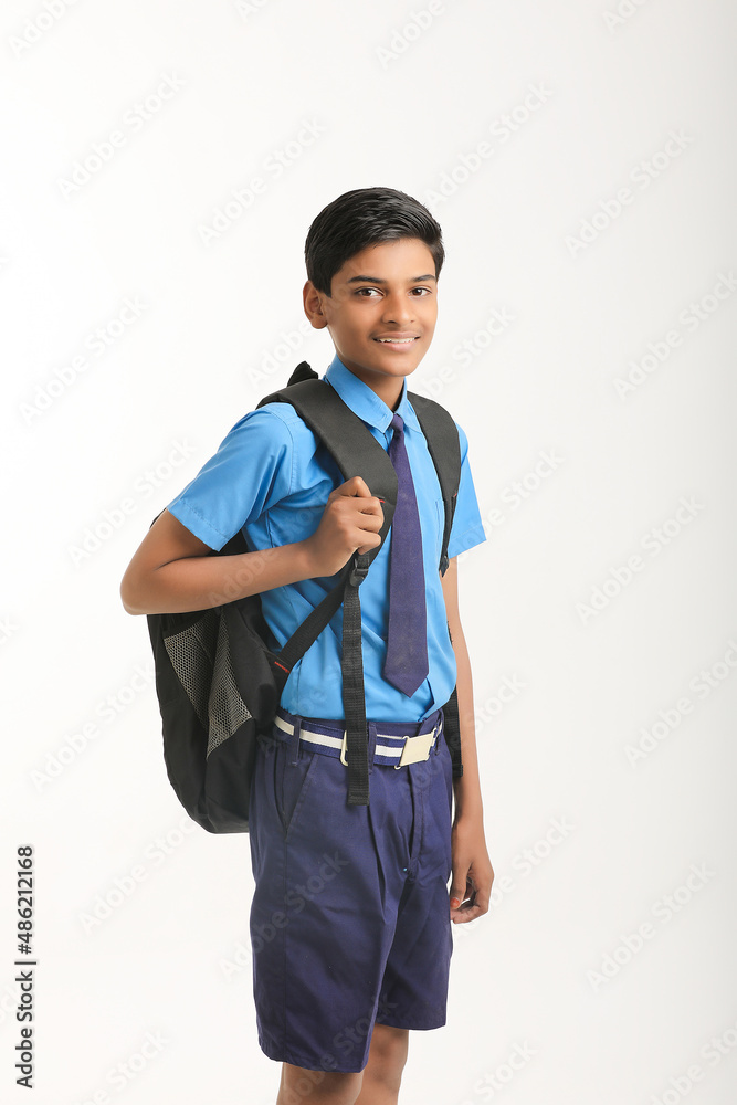 Indian school boy standing on white background. Stock Photo | Adobe Stock