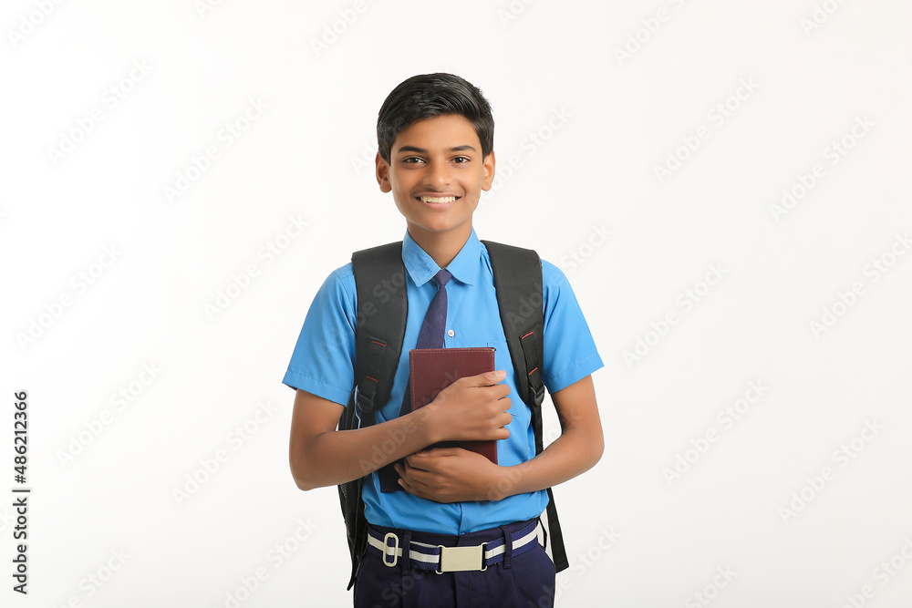 Indian school boy in uniform and holding diary in hand on white ...