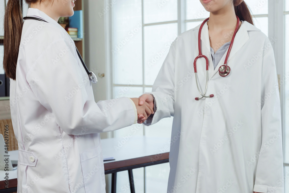 4k, Two Asian female doctors in white shirts are holding hands ...