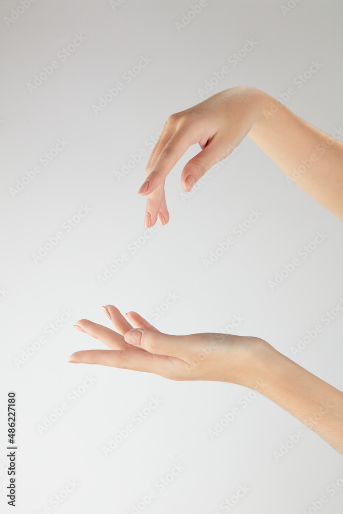 Hand model holding a cosmetic jar with a white background for cosmetic ...