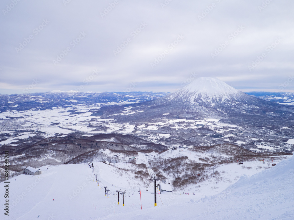 Snowy volcano and town viewed from a ski resort (Niseko, Hokkaido ...