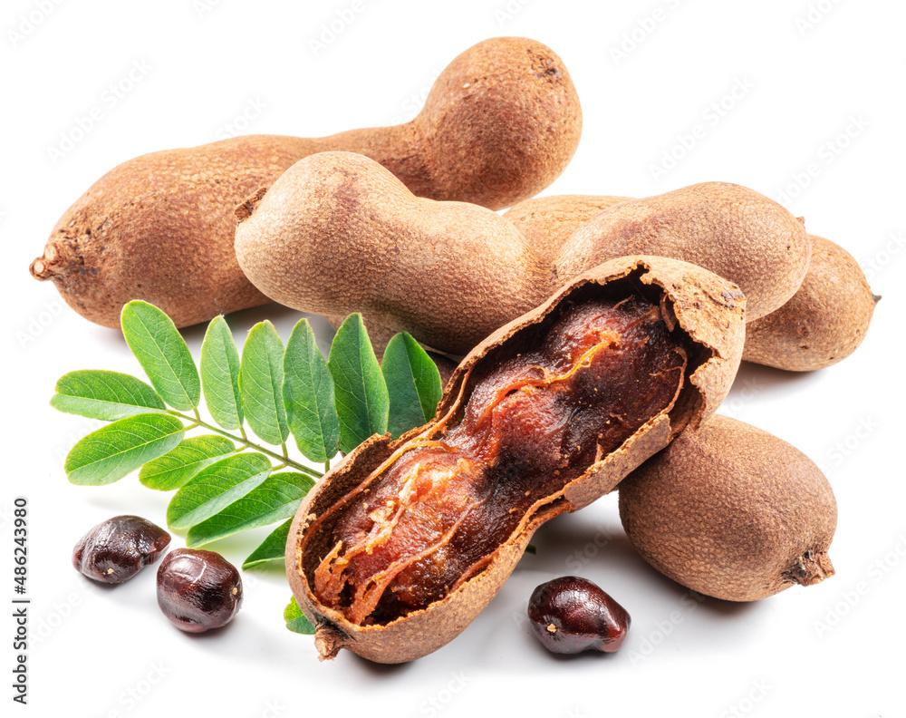 Ripe tamarind fruit, leaves and some tamarind seeds isolated on white ...