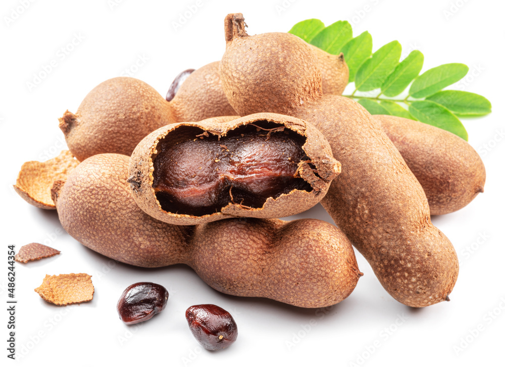 Ripe tamarind fruit, leaves and some tamarind seeds isolated on white ...