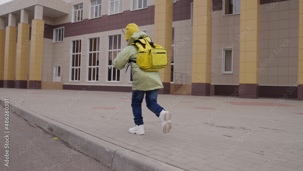 little girl run through the schoolyard to class, child rushing school ...