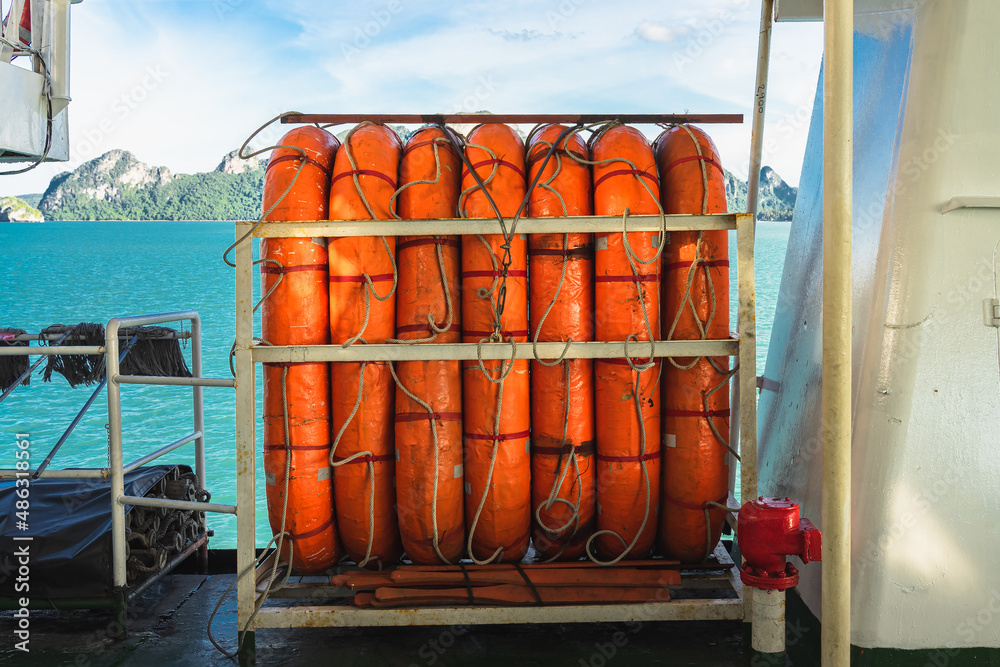 Orange inflatable lifeboats on ferry deck for emergencies and maritime ...