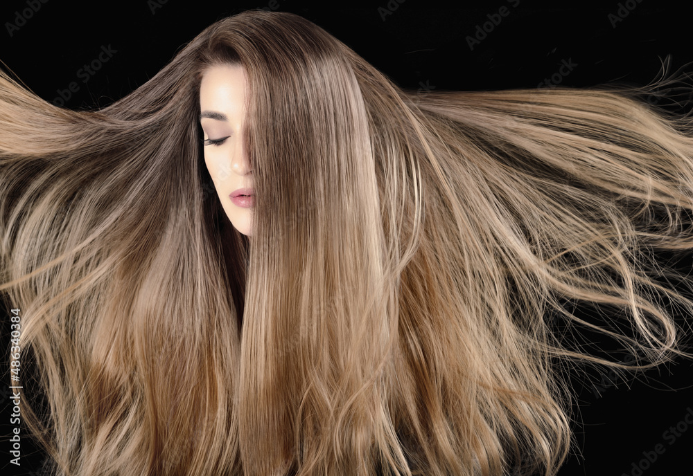 Woman with long straight hair flying around head. Beautiful model girl ...
