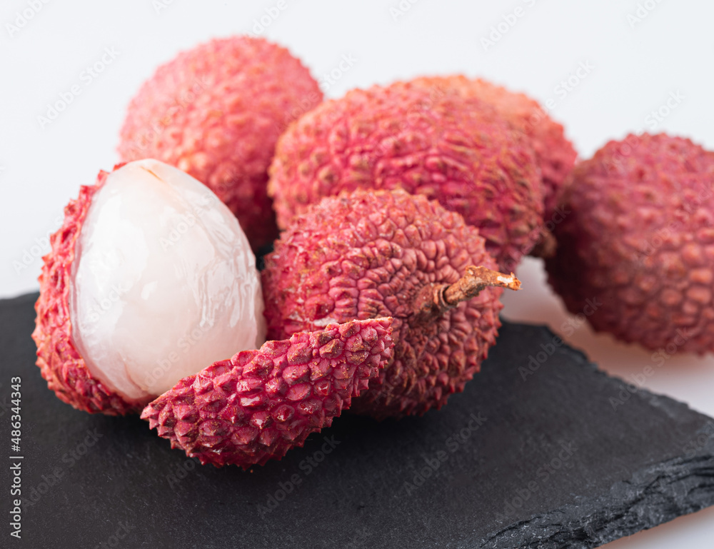 Lychee with peel and peeled lychee isolated on a white background Stock ...