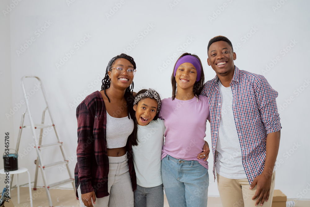 Smiling family embrace each other, look into the camera, relax after ...