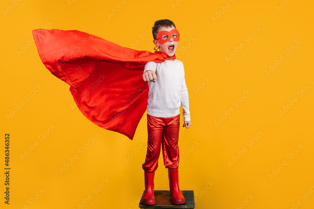 Boy in superhero uniform pretending to fly Stock Photo | Adobe Stock