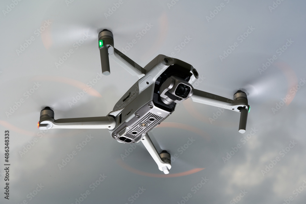 Drone air 2s from dji hovers in front of gray sky. The flying object is ...