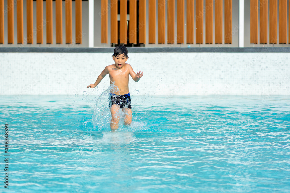 Asian Young Boy Having a good time in swimming pool, He Jumping and ...