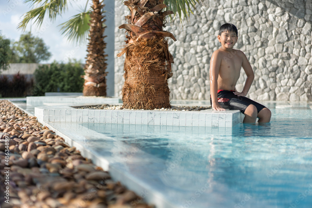 Asian Young Boy Having a good time in swimming pool, He Jumping and ...