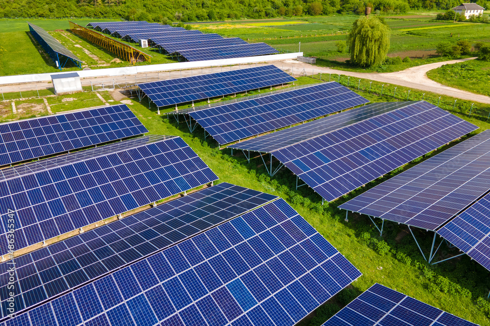 Aerial view of large sustainable electrical power plant with rows of ...