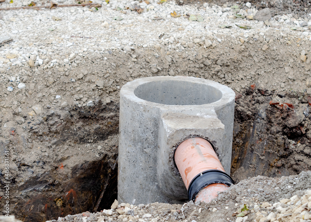 Pre-cast road gully unit installed into the ground and connected to ...