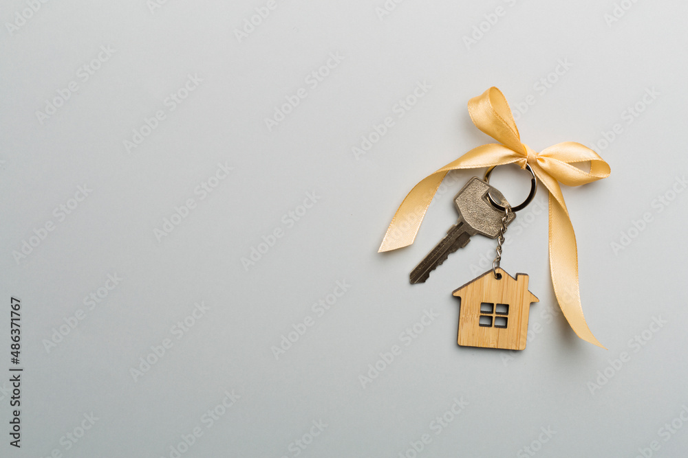 House key with golden bow on color background Stock Photo | Adobe Stock